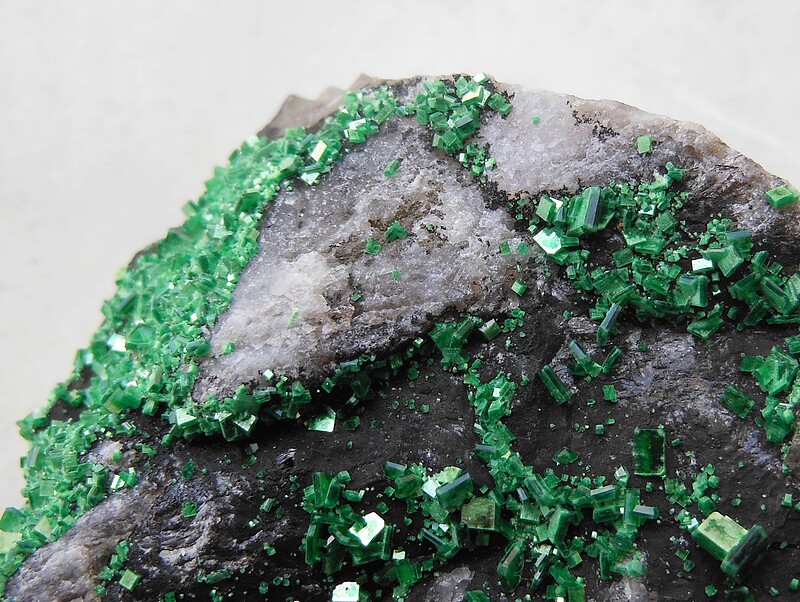 Tabular epitaxial green crystal of torbernite on yellow autunite.Photo ...