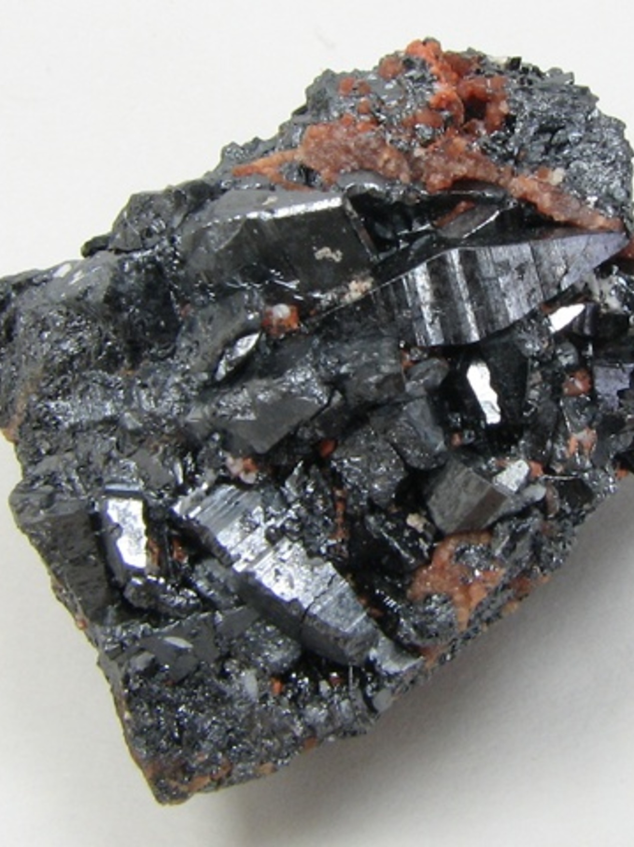 Modified black cuboctaherdons of braunite on yellow brown amphibole.