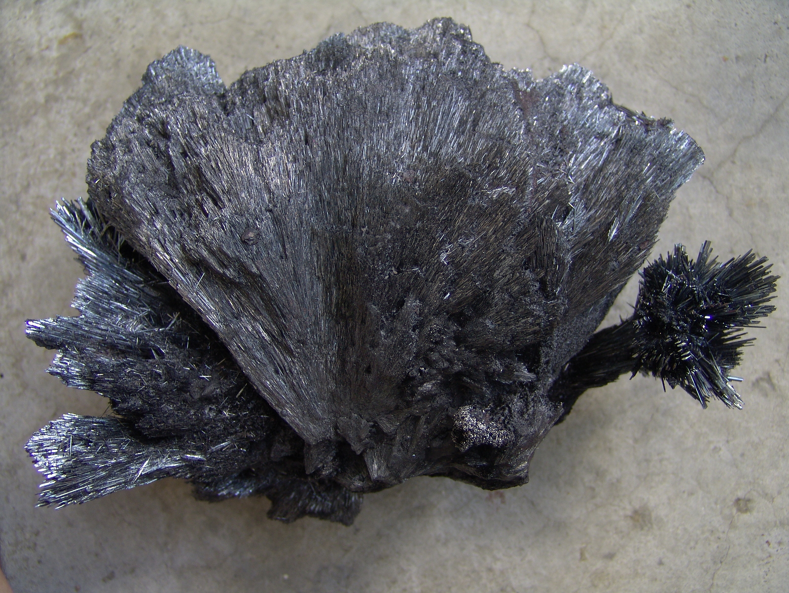 Lustrous, metallic berthierite crystals with bladed clusters to over 10 cm.